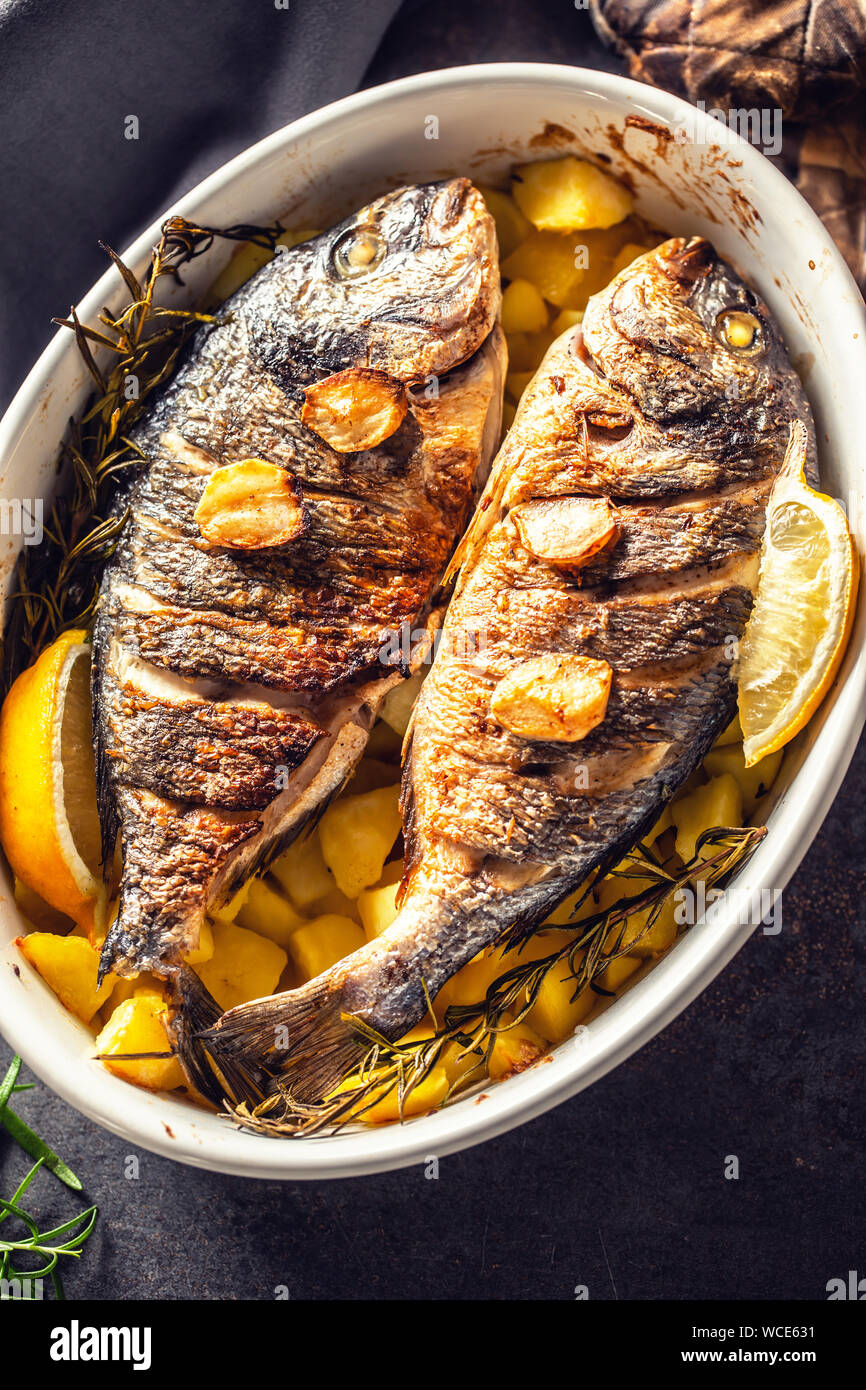 Roasted mediterranean fish bream with potatoes rosemary and lemon Stock ...