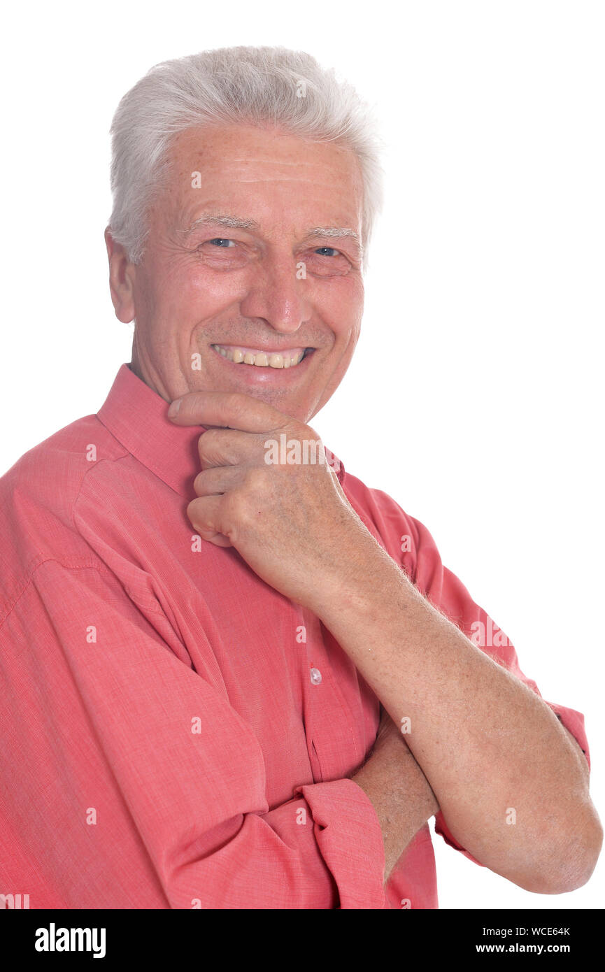 Portrait of handsome senior man wearing pink shirt isolated on white ...