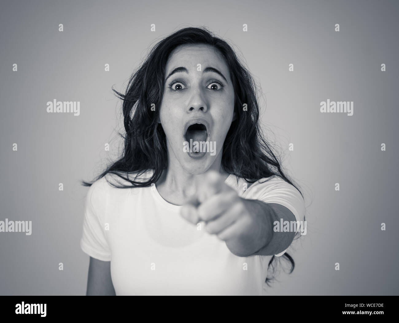 Excited latin teenager girl surprised and shocked feeling amazed by ...