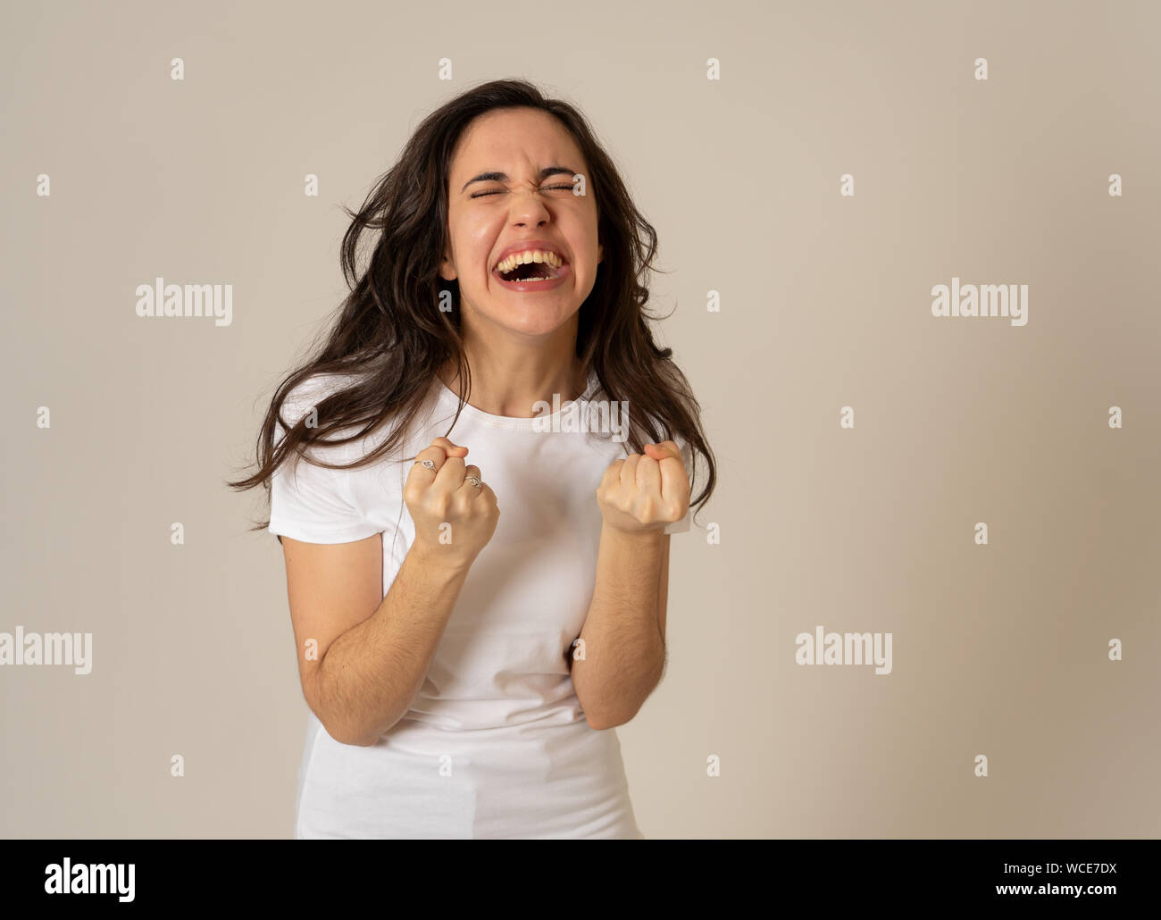 Young attractive latin woman celebrating success winning or feeling ...