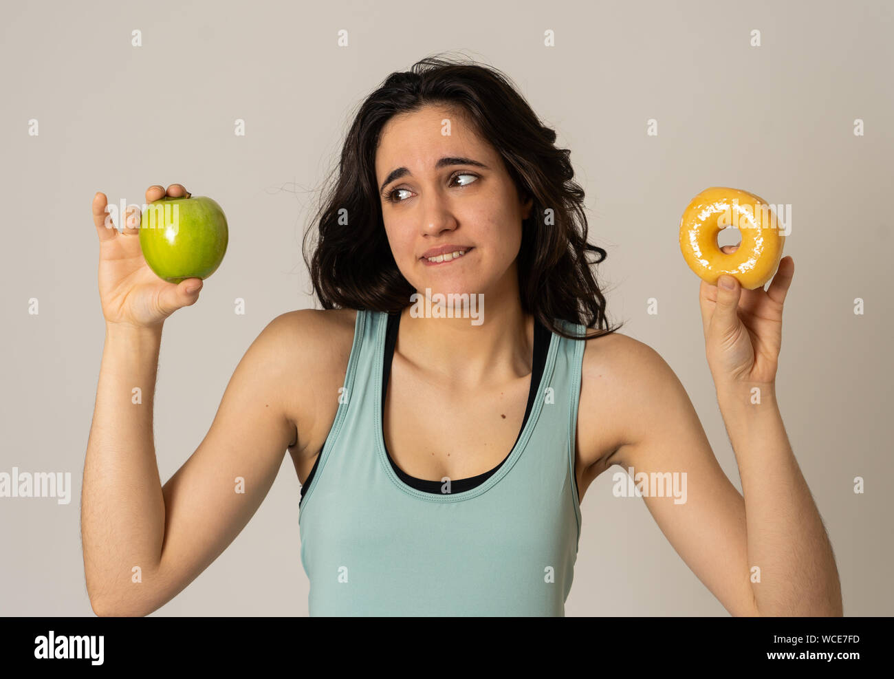 Young woman tempted junk food hi-res stock photography and images - Alamy