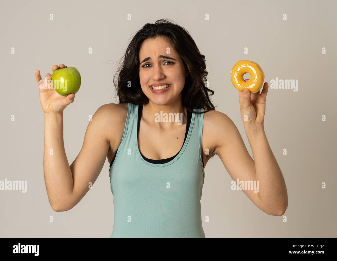 Young woman tempted junk food hi-res stock photography and images - Alamy