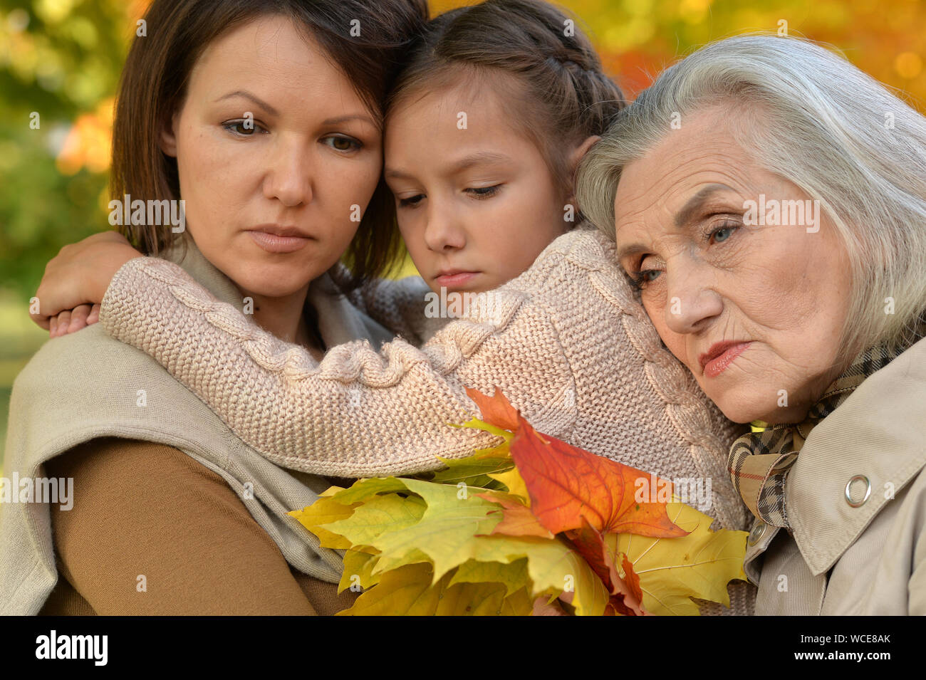 Close up portrait of sad mother, grandmother and daughter Stock Photo ...