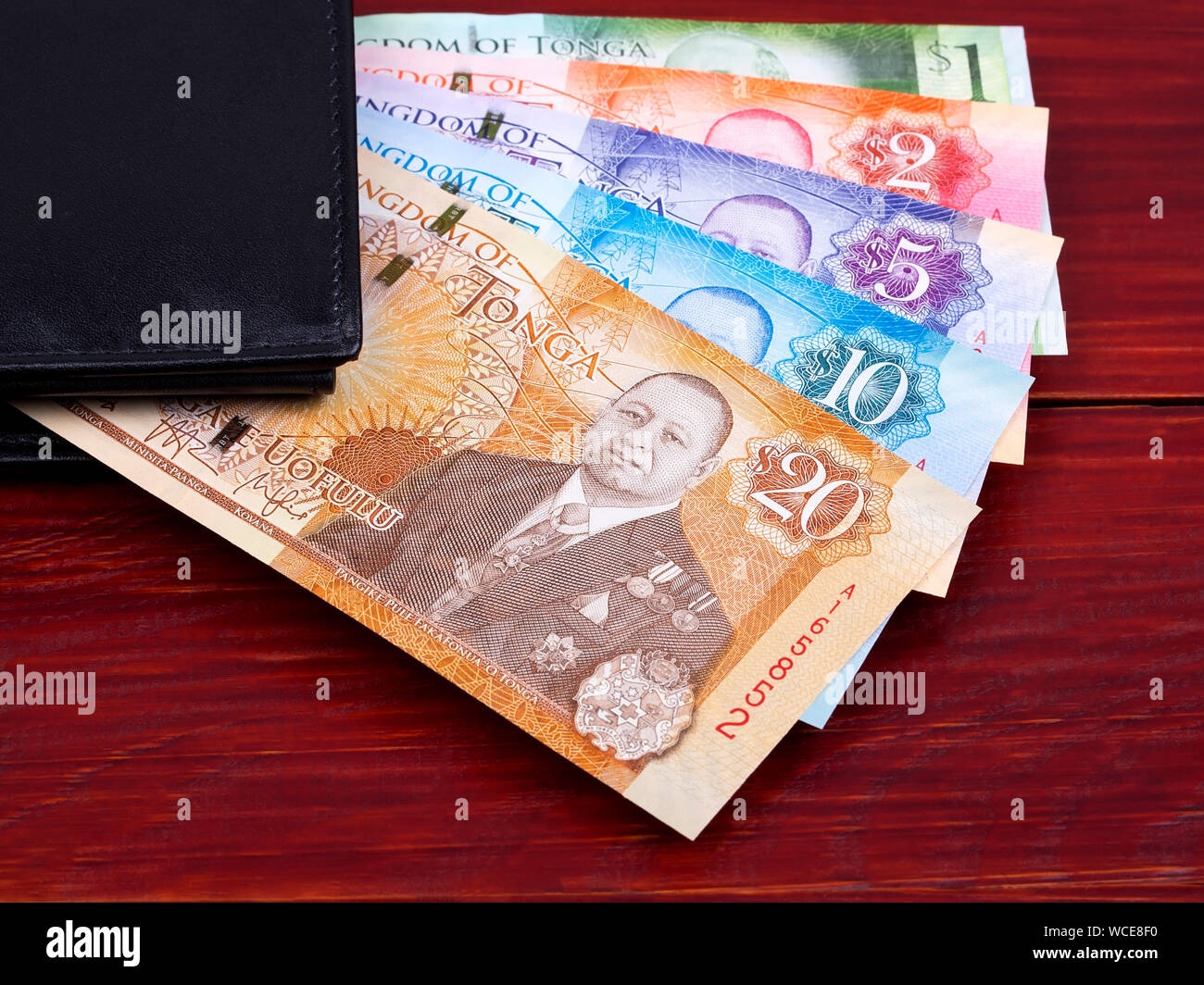 Tongan money in the black wallet Stock Photo - Alamy