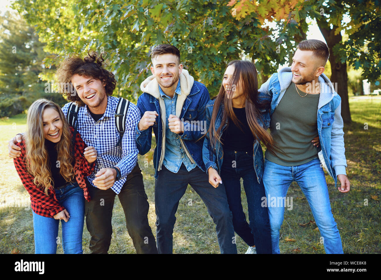 Happy friends are laughing at the park Stock Photo - Alamy