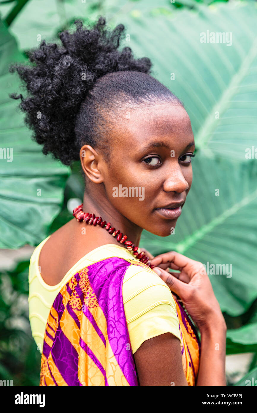 Close up african woman in green park half-turned Stock Photo - Alamy