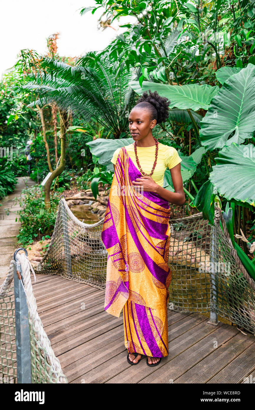 Young african woman in greenhouse among green trees Stock Photo - Alamy