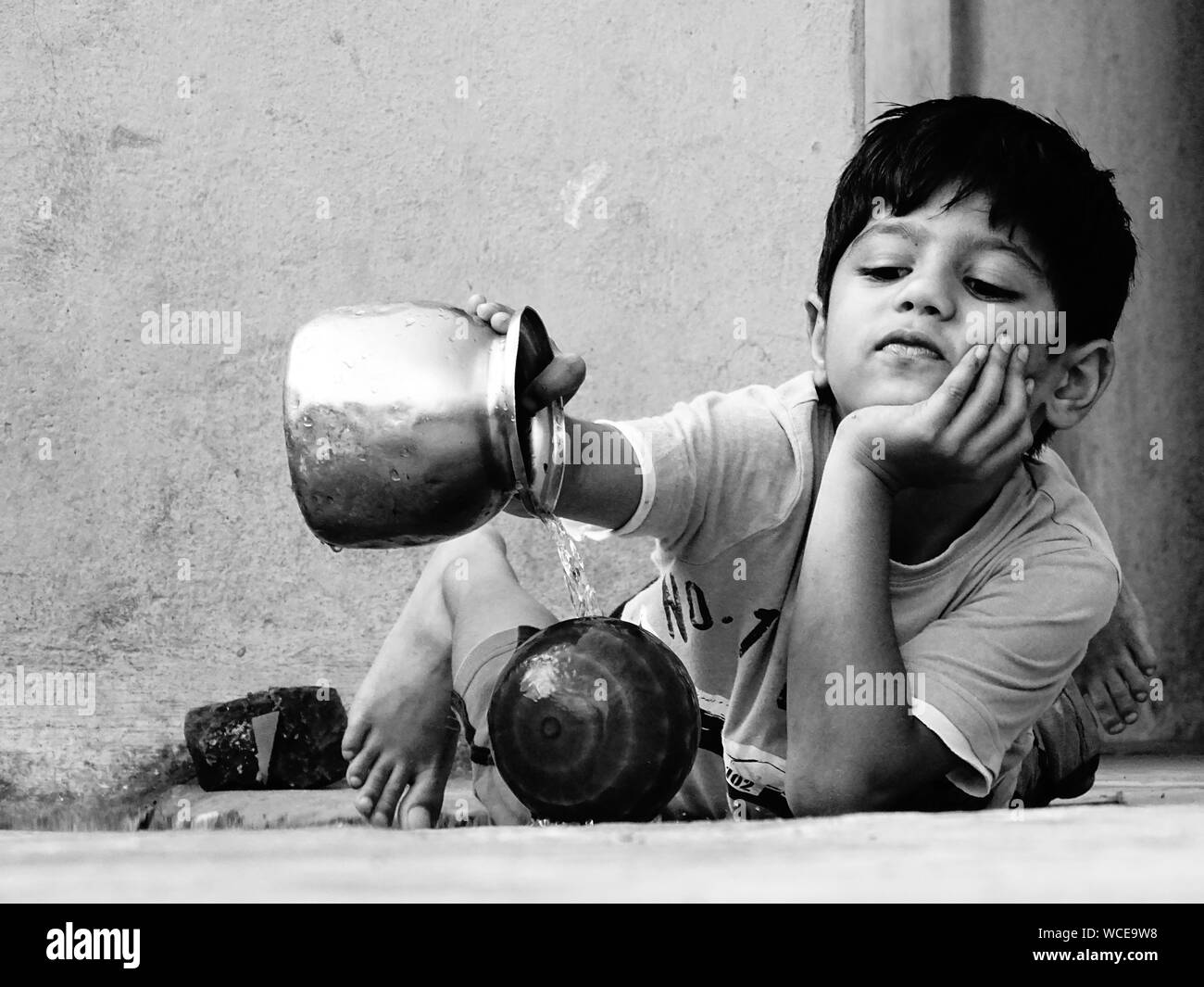 Boys pouring water hi-res stock photography and images - Alamy
