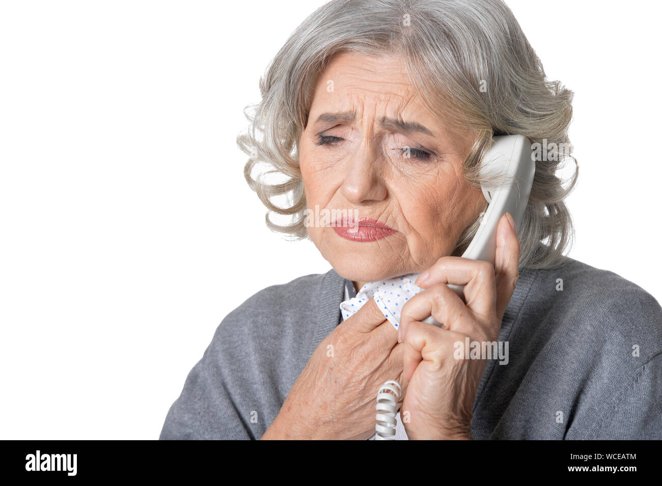 Senior woman with headache talking on phone isolated on white ...