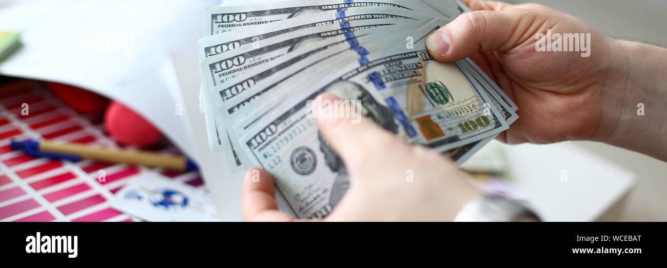 Male hands counting money from huge pack Stock Photo - Alamy