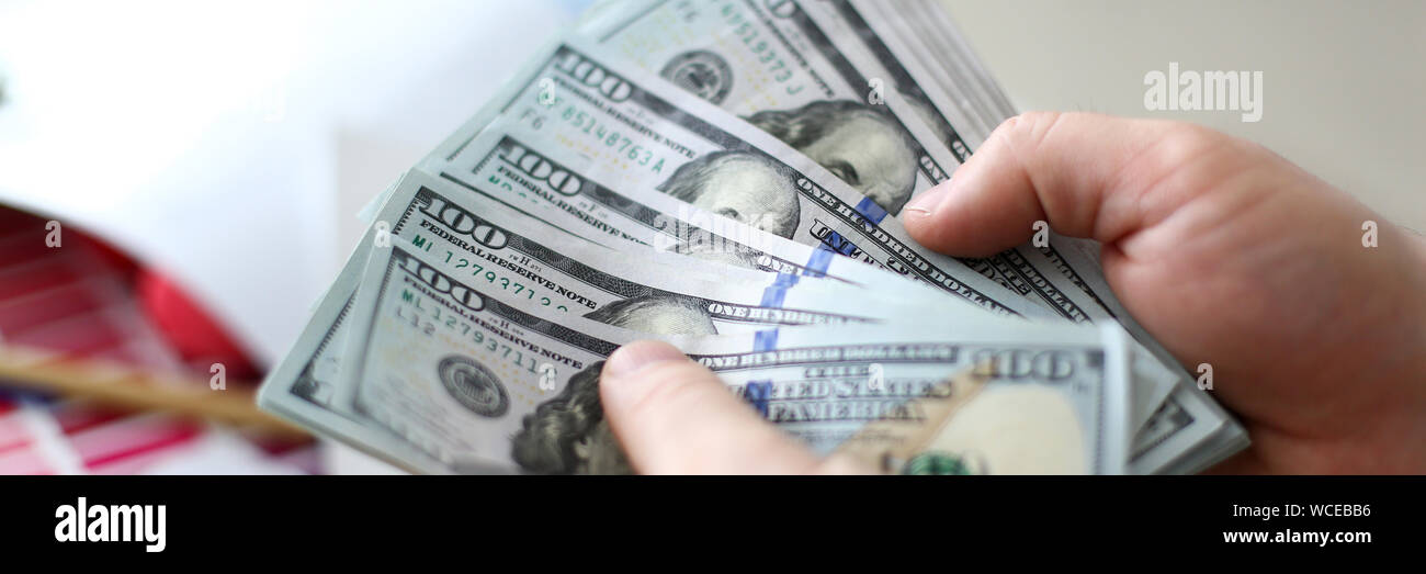 Male hands counting money from huge pack Stock Photo - Alamy