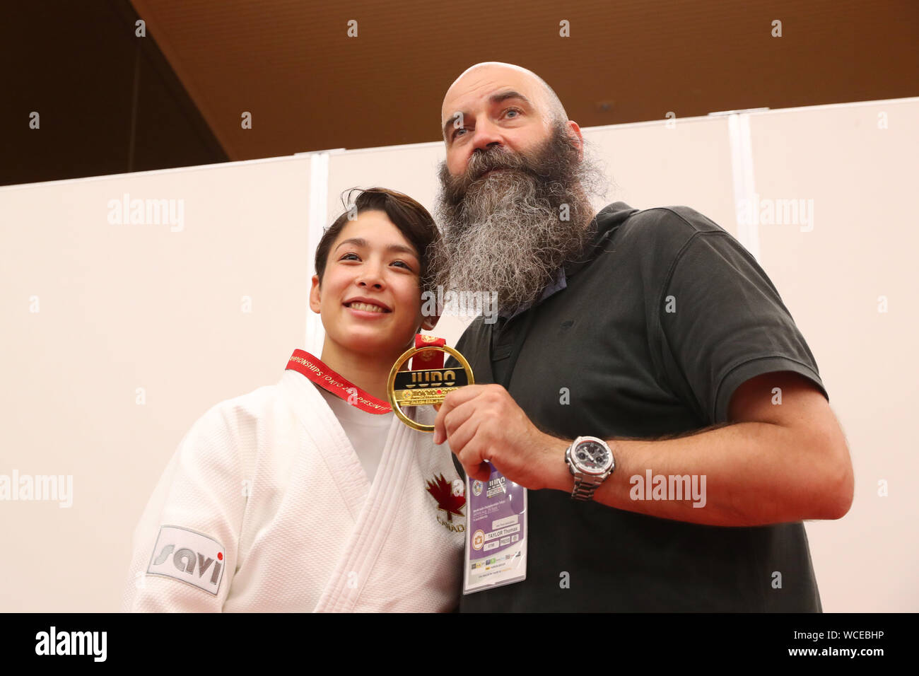 Champion Christa Deguchi of Canada poses with her father Taylor Thomas ...