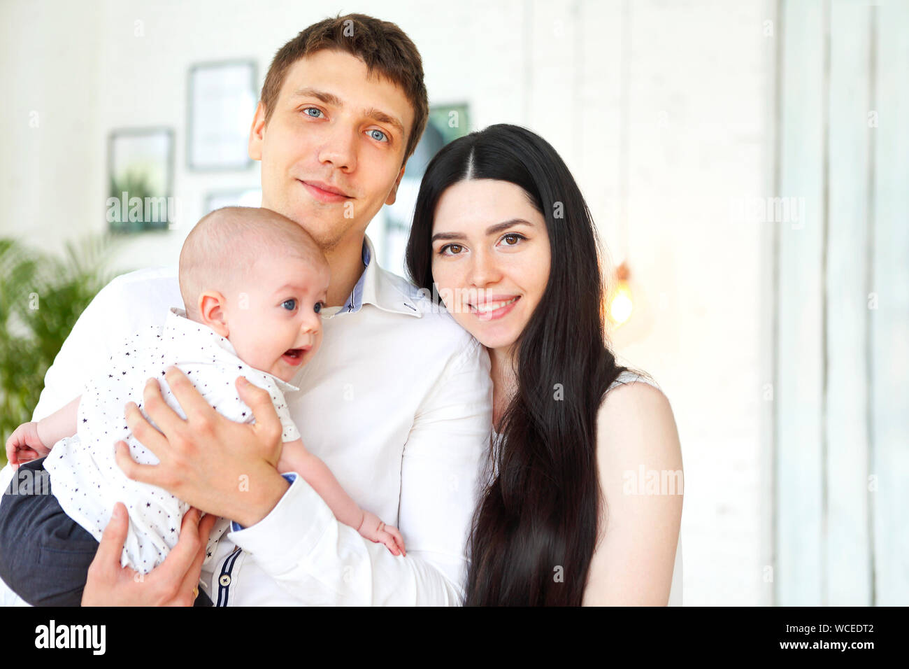 Young happy family with little baby son at home Stock Photo - Alamy