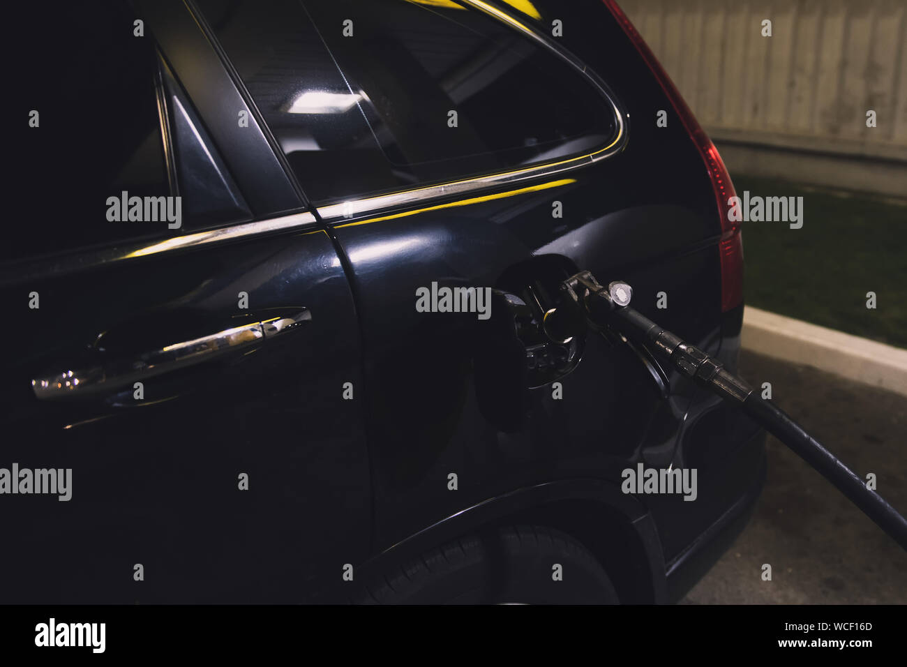 Refueling cars tank with gas oil at the petrol station. Black car in ...