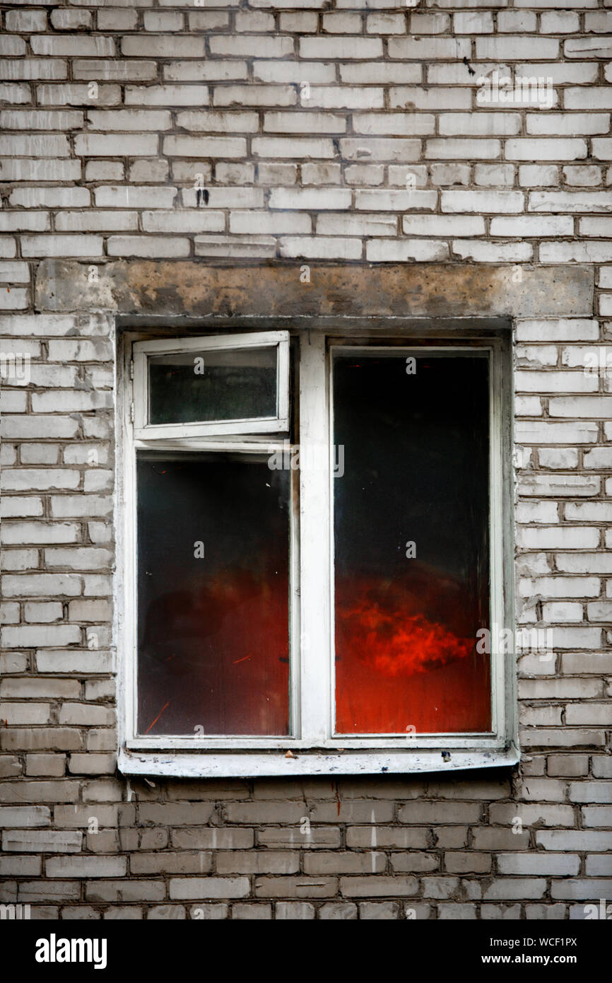 Photo of brick house with with fire in window during day Stock Photo ...