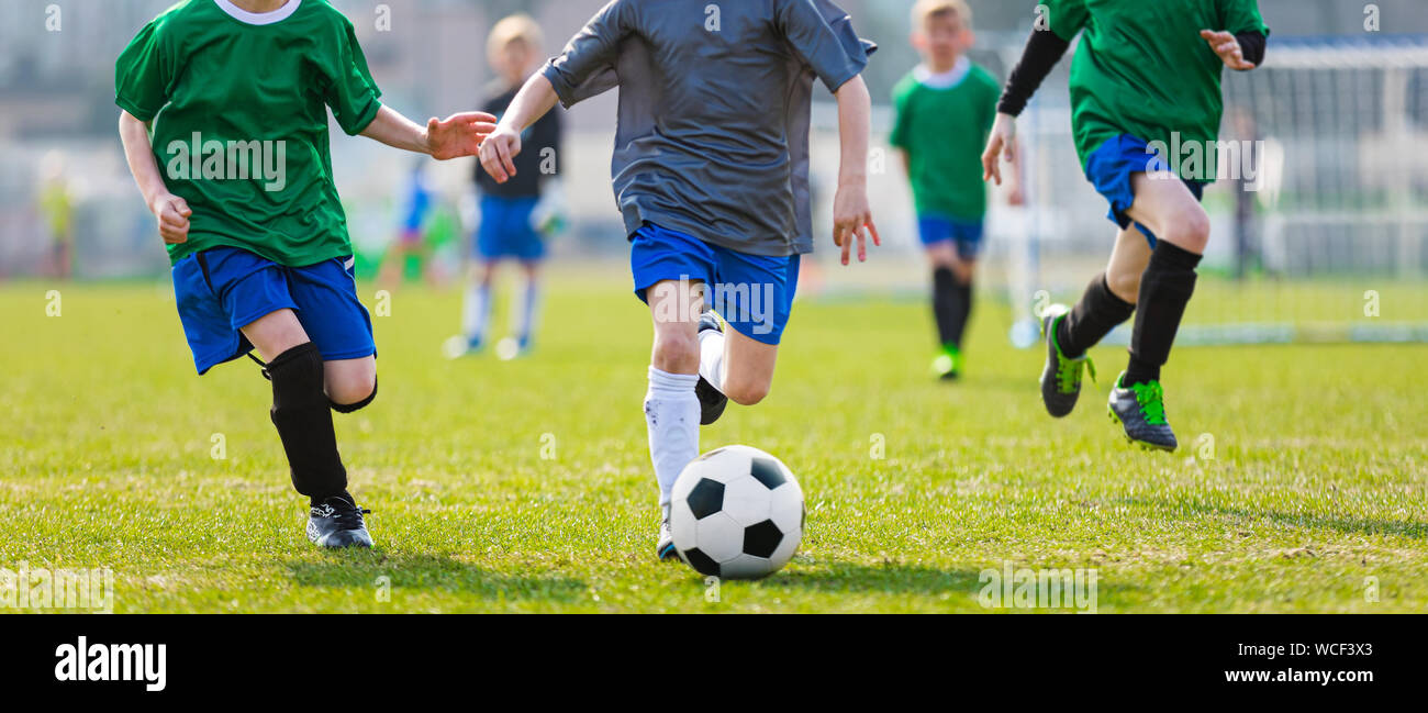 Boy Kicking Soccer Ball. Running Soccer Football Players. Five Junior ...