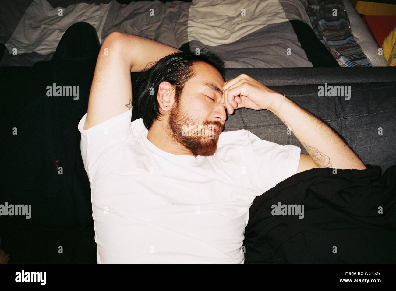Handsome man relaxing on bed hi-res stock photography and images - Alamy