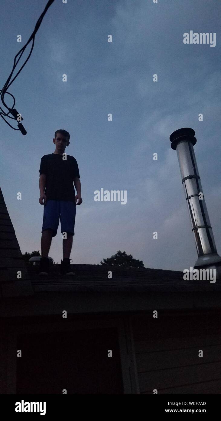 Young man standing rooftop hi-res stock photography and images - Alamy