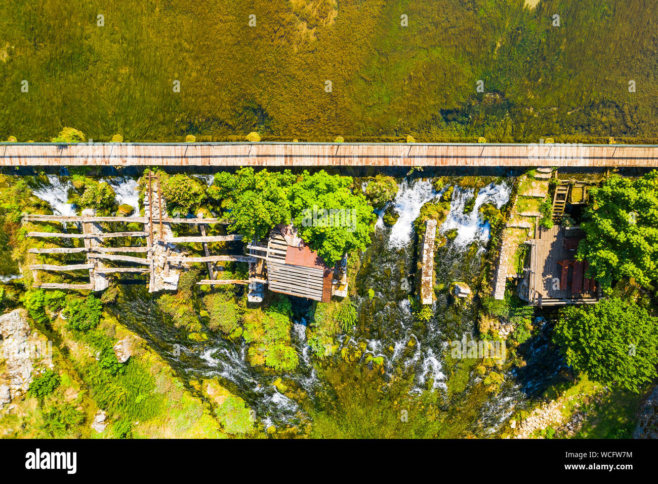 Tonkovic vrilo, river source of Gacka and wooden bridge over the river ...