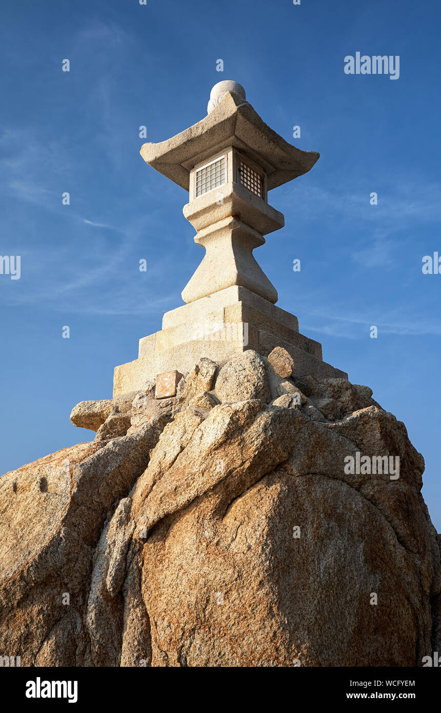 Traditional japanese stone lantern on boulder near Take Island in ...
