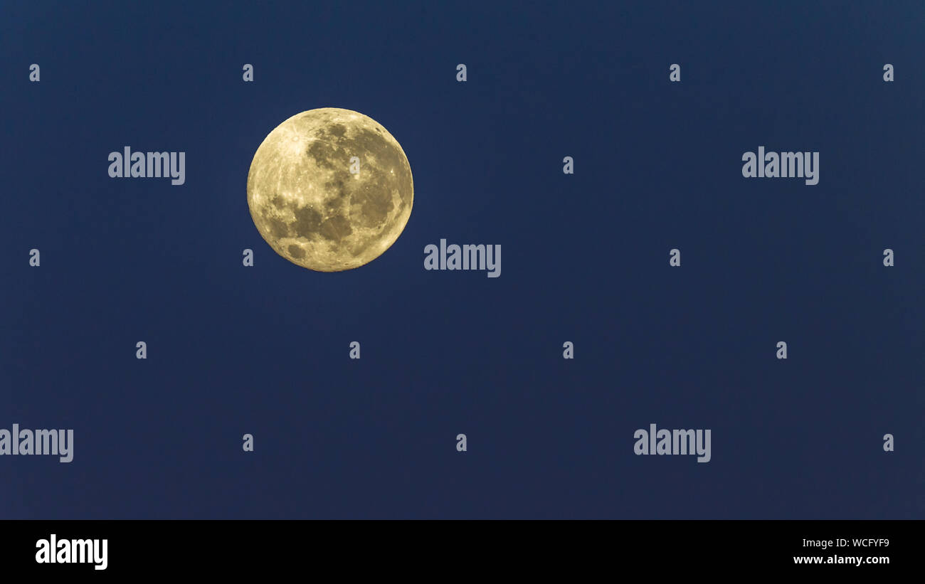 Full moon planet detail dawn morning blue sky sunlight reflections ...