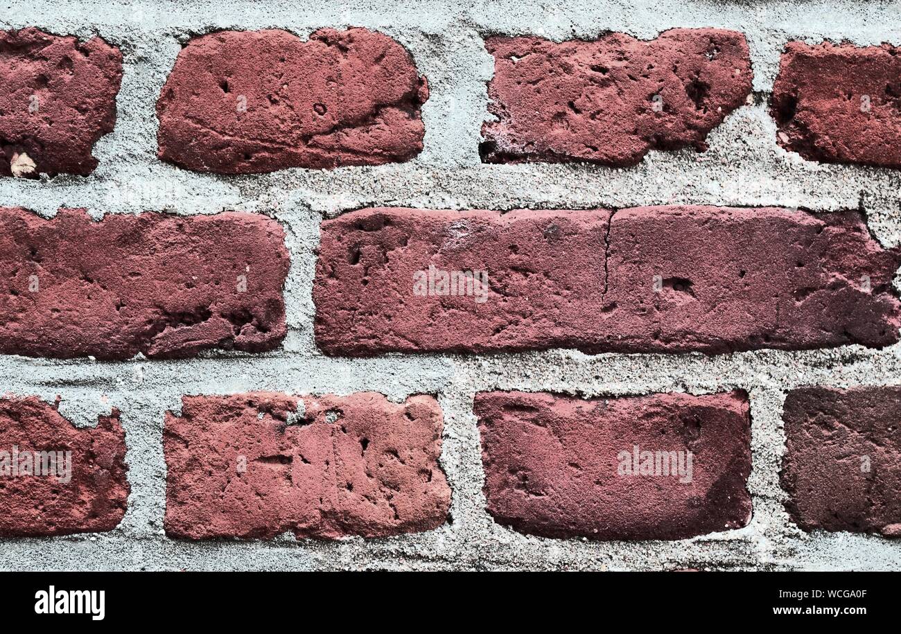 Detailed closeup view on aged and weathered red bricks walls in a ...