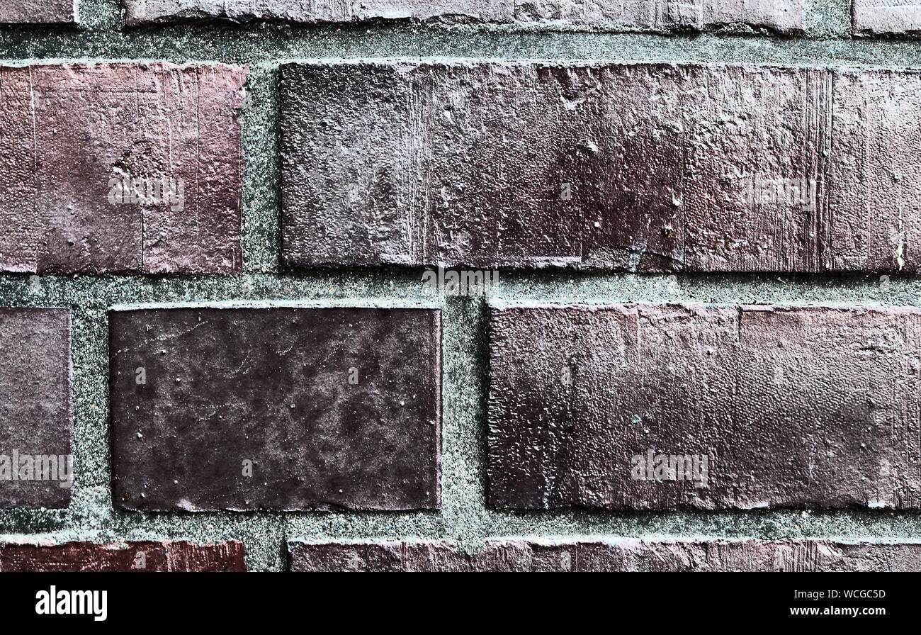 Detailed closeup view on aged and weathered red bricks walls in a ...