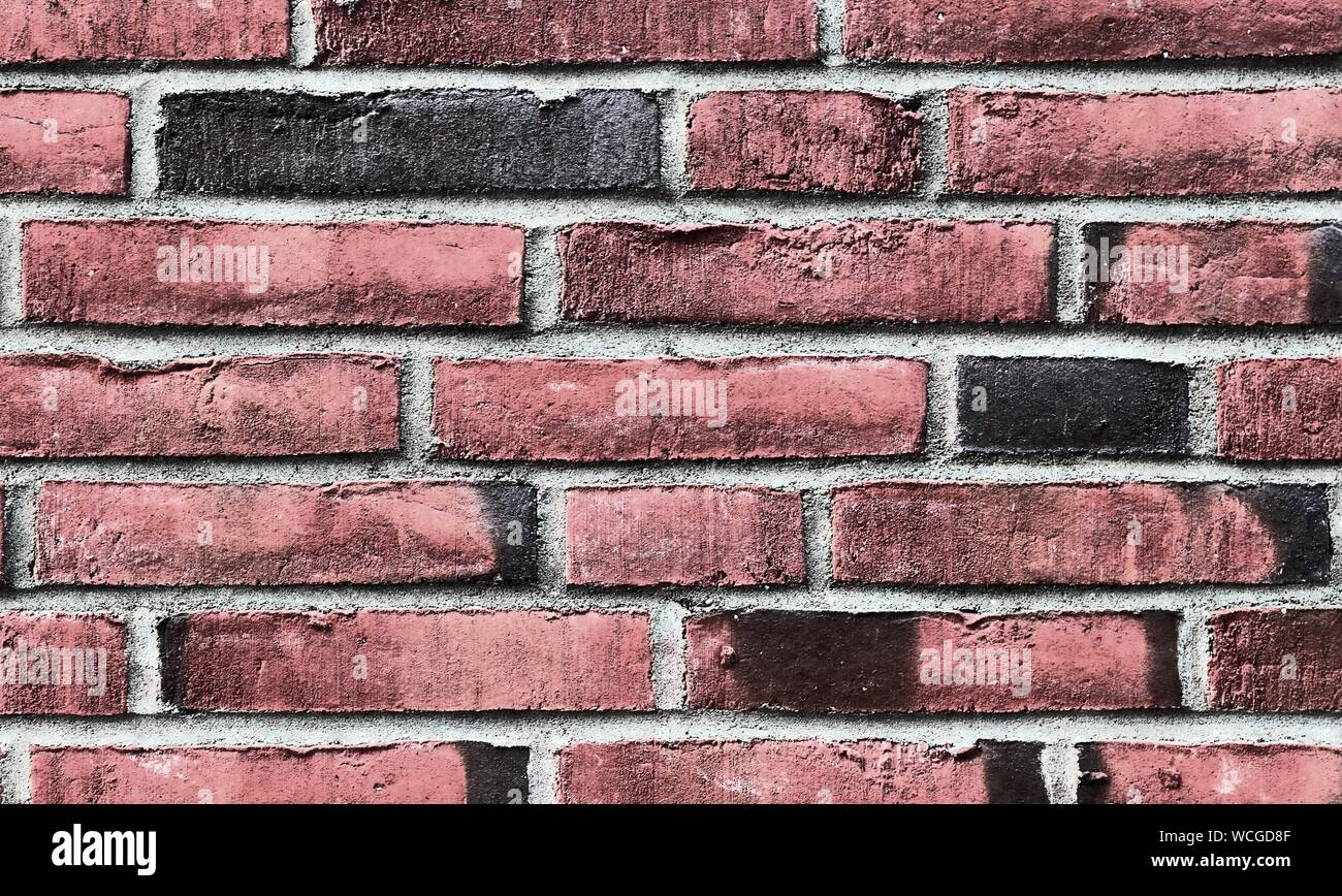 Detailed closeup view on aged and weathered red bricks walls in a ...