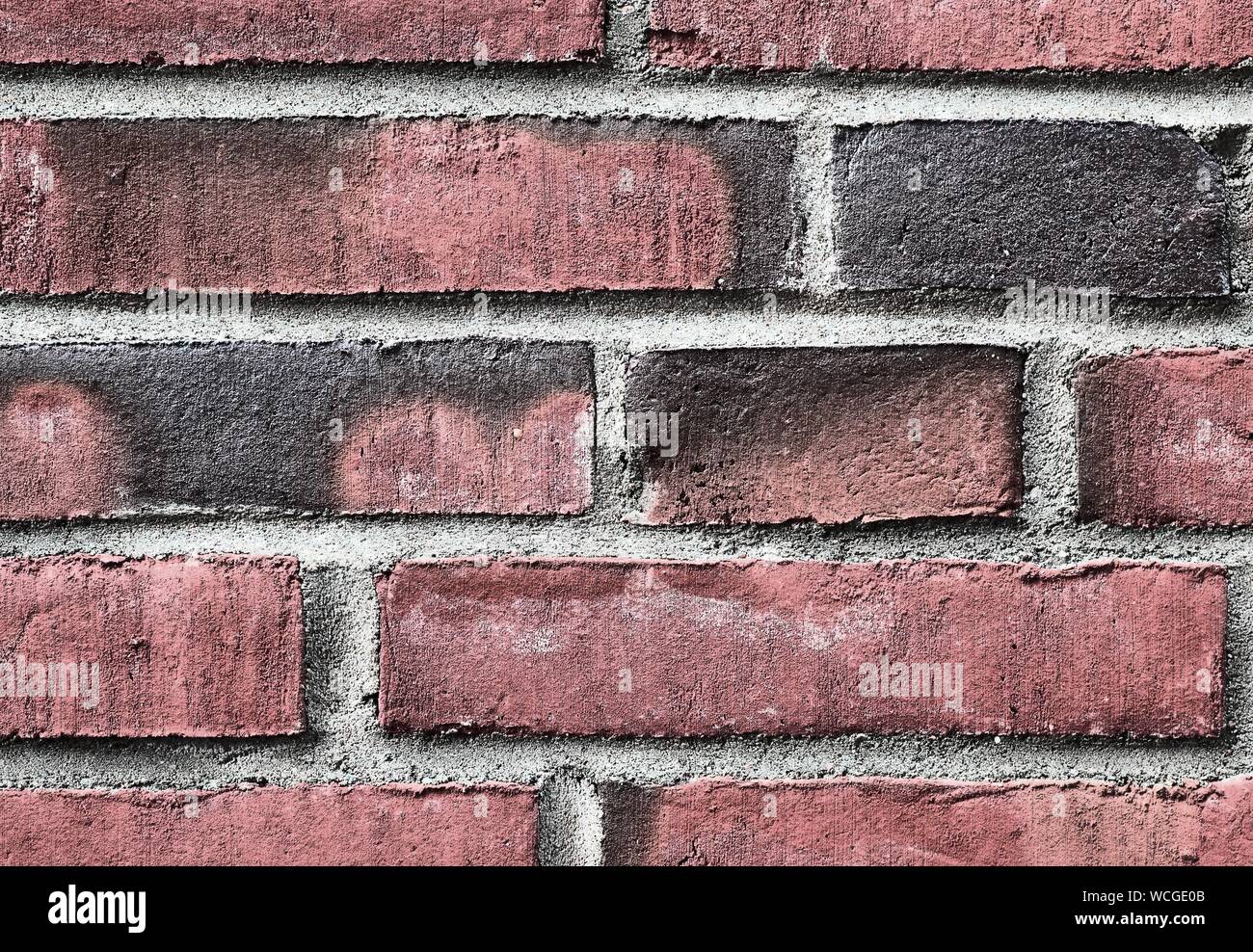 Detailed closeup view on aged and weathered red bricks walls in a ...