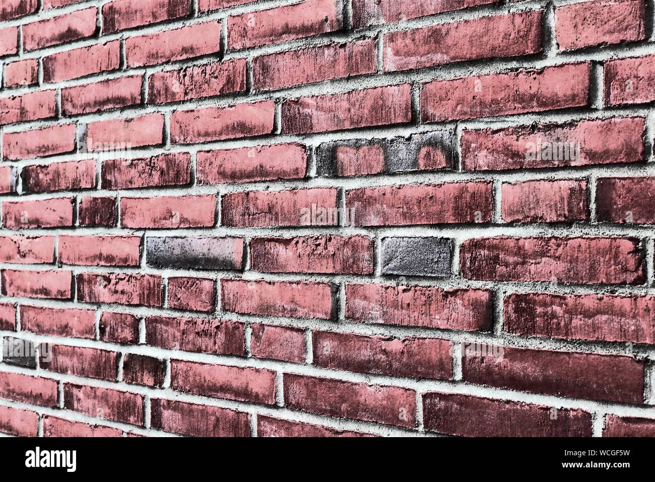 Detailed closeup view on aged and weathered red bricks walls in a ...