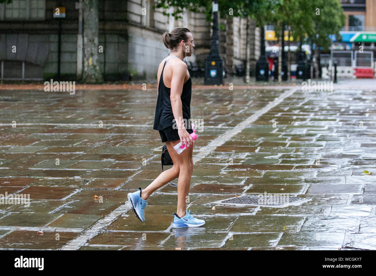 Preston, Lancashire. UK Weather 28th Aug 2019. Male jogger in the rain ...