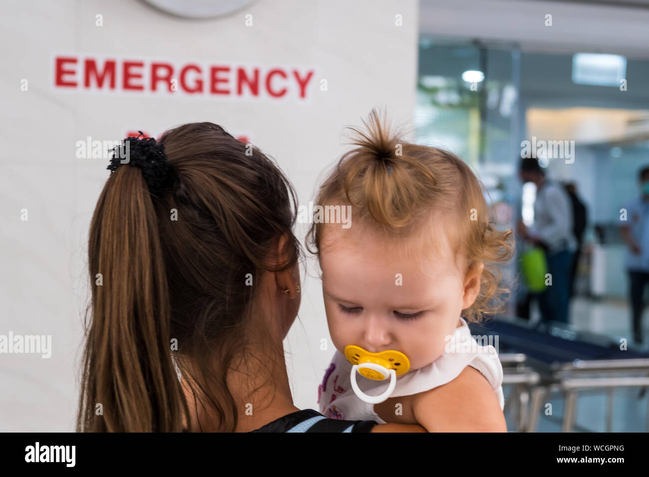 Mom and child come in in the emergency room at the hospital in Pattaya ...