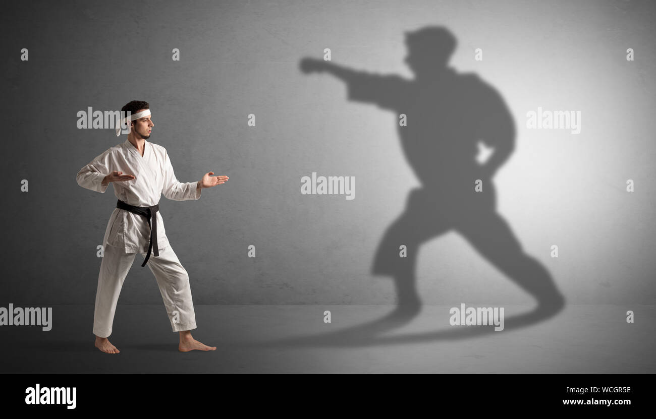 Young karate man confronting with his own shadow Stock Photo - Alamy