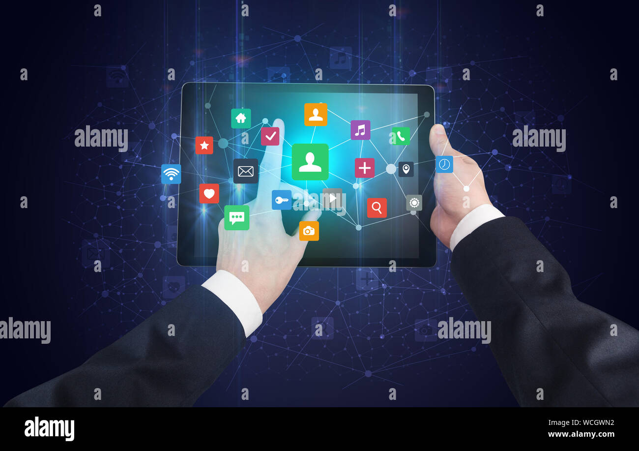 Hand using tablet with colorful bounce application symbols and icons ...