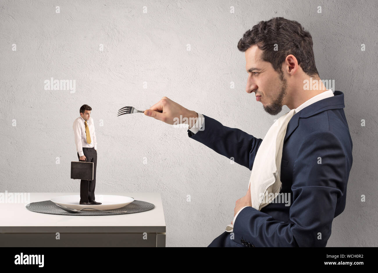 Tiny scared weak businessman almost devoured by great power Stock Photo ...