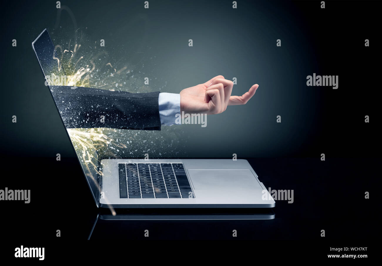 Hand coming out of a laptop with sparkling effects Stock Photo - Alamy
