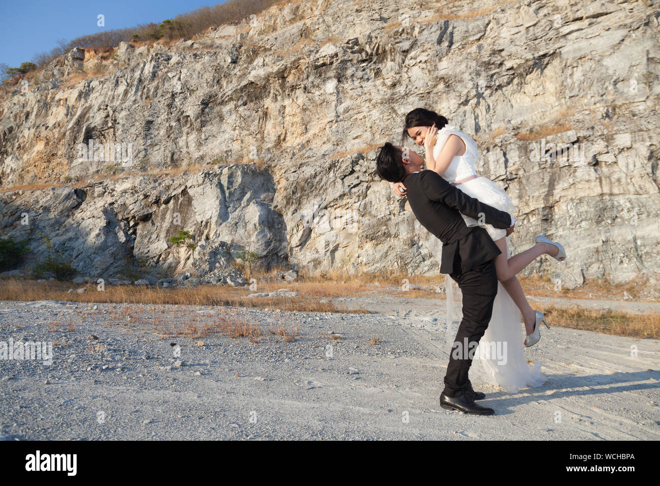 Groom lifting bride hi-res stock photography and images - Alamy