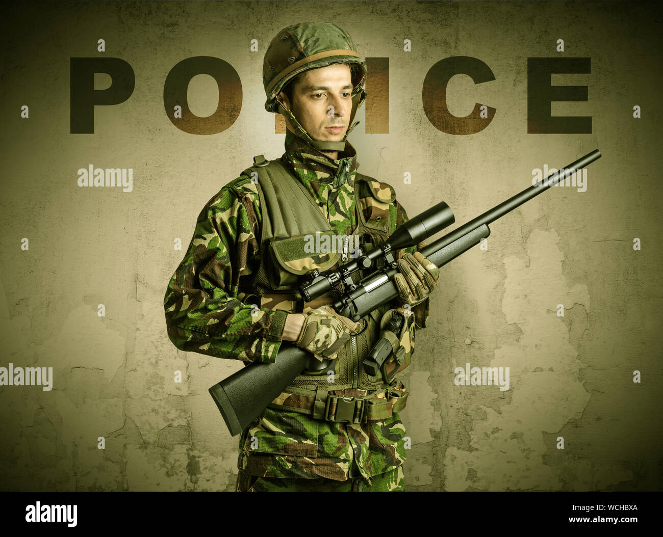 Uniformed armed soldier with damaged wall background Stock Photo - Alamy