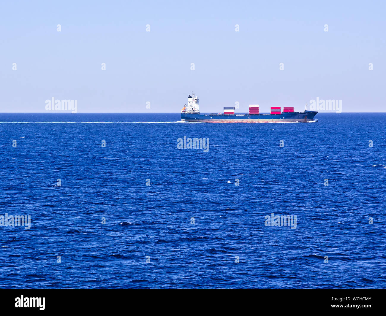 Large cargo ship sailing at textured sea Stock Photo - Alamy