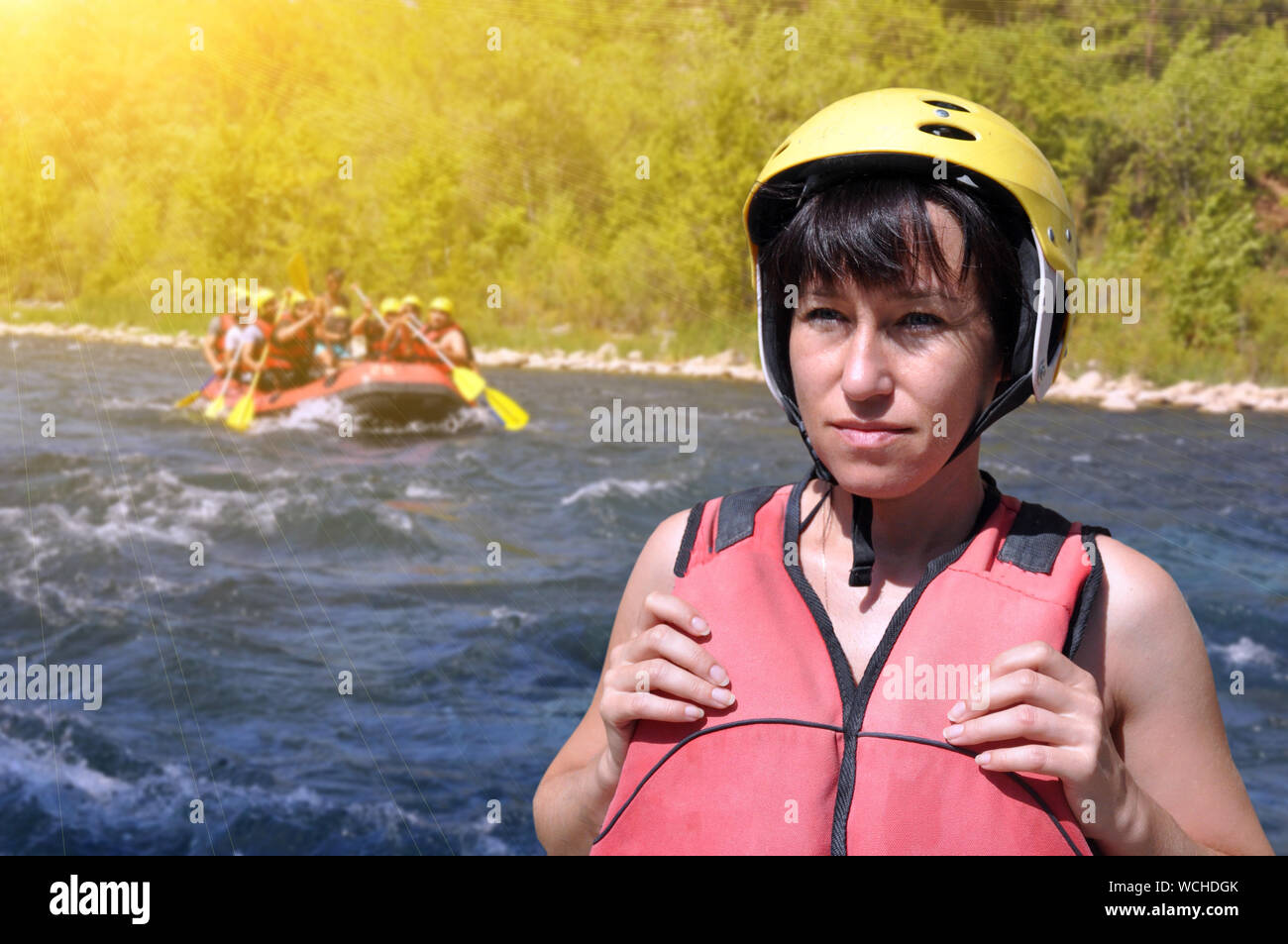 Beautiful young girl. Rafting. Standing on the background of the river ...