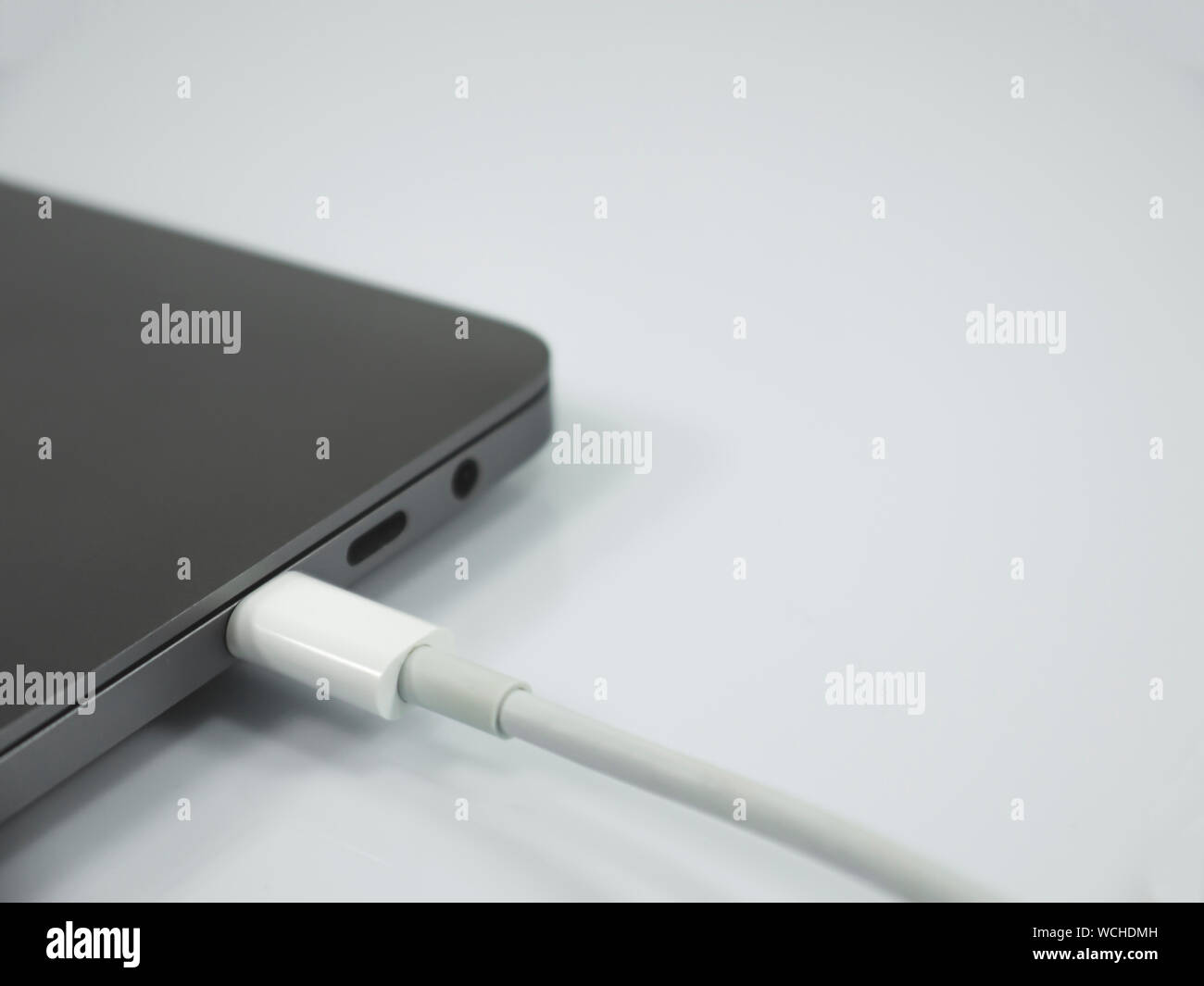 Type C cable and laptop on the white background Stock Photo - Alamy