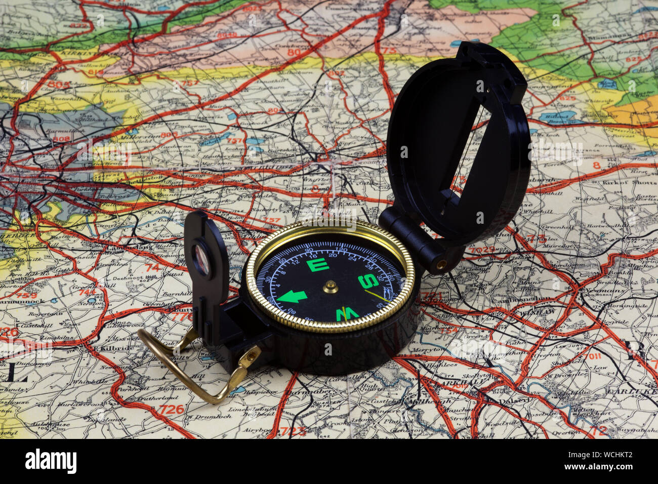 Compass sitting on old road map of Scotland Stock Photo - Alamy