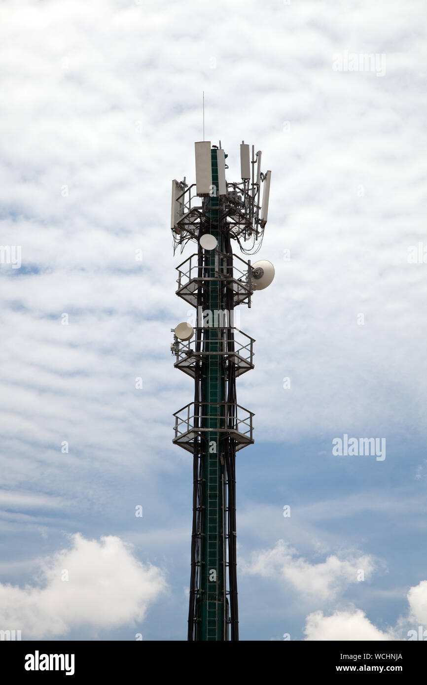 Mobile phone tower against blue cloudy sky Stock Photo - Alamy