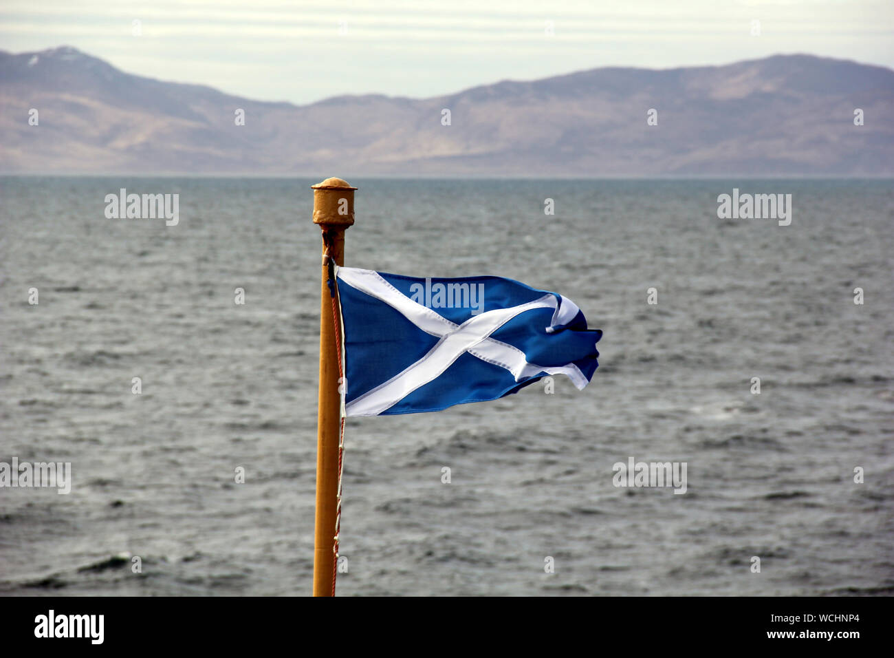 Scottish Saltire flag blowing in the breeze on board ferry to Isle of ...