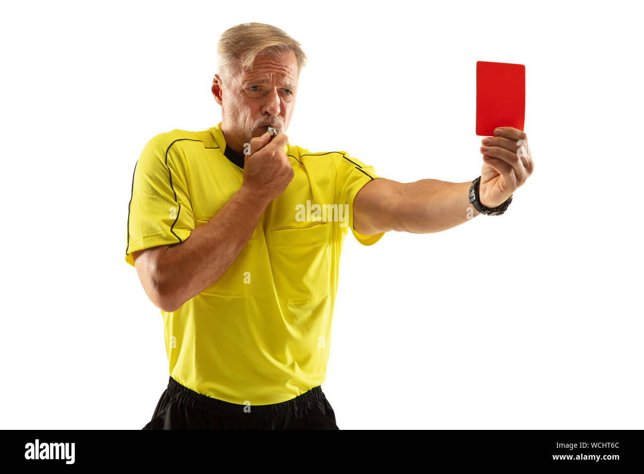Referee showing a red card and gesturing to a football or soccer player ...