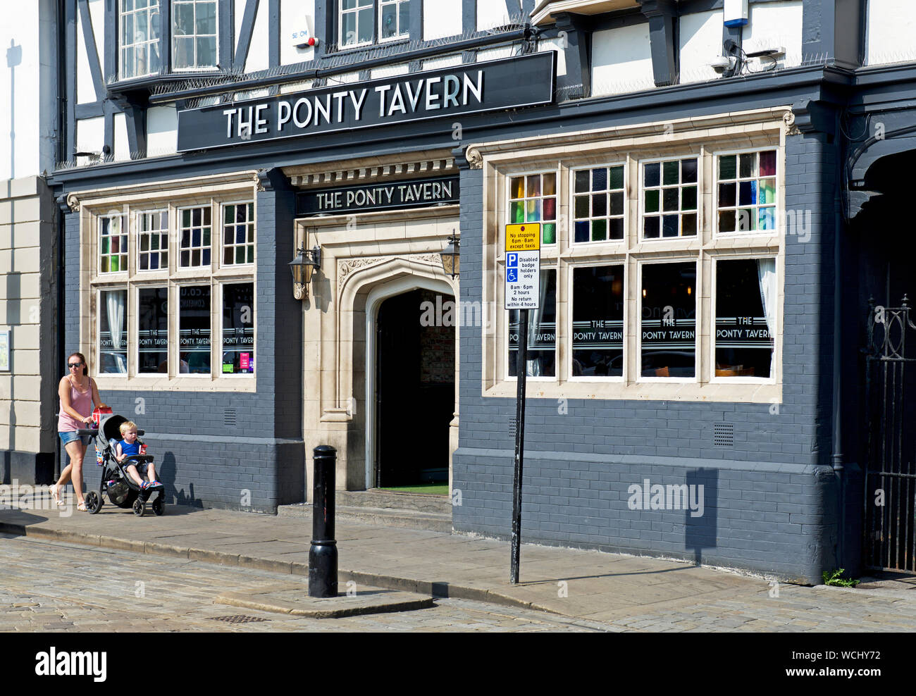 Woman with pushchair walking past the Ponty Tavern, Cornmarket ...