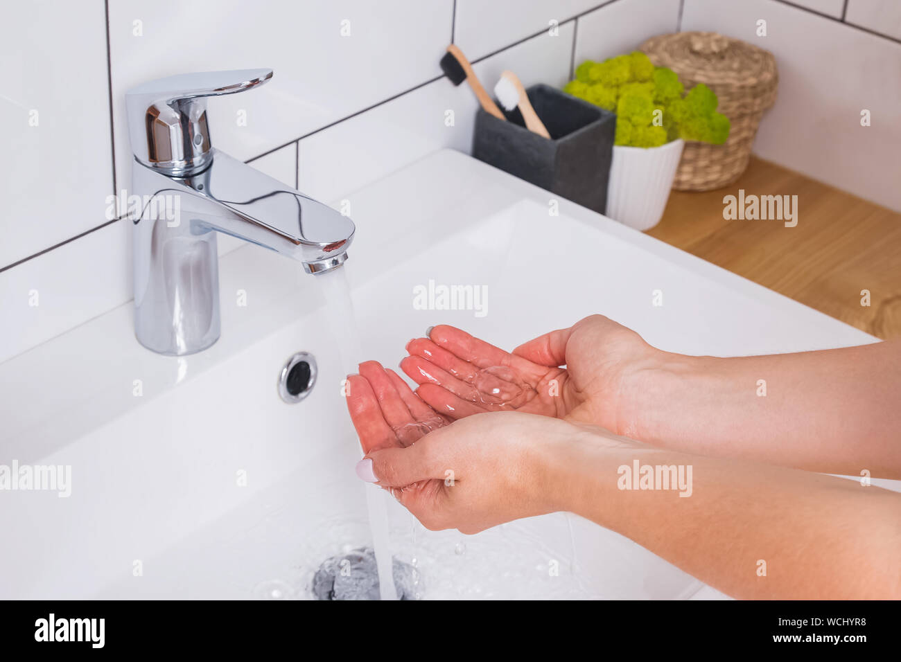 Process of washing hands close-up. Woman's hands rinsing with the water ...