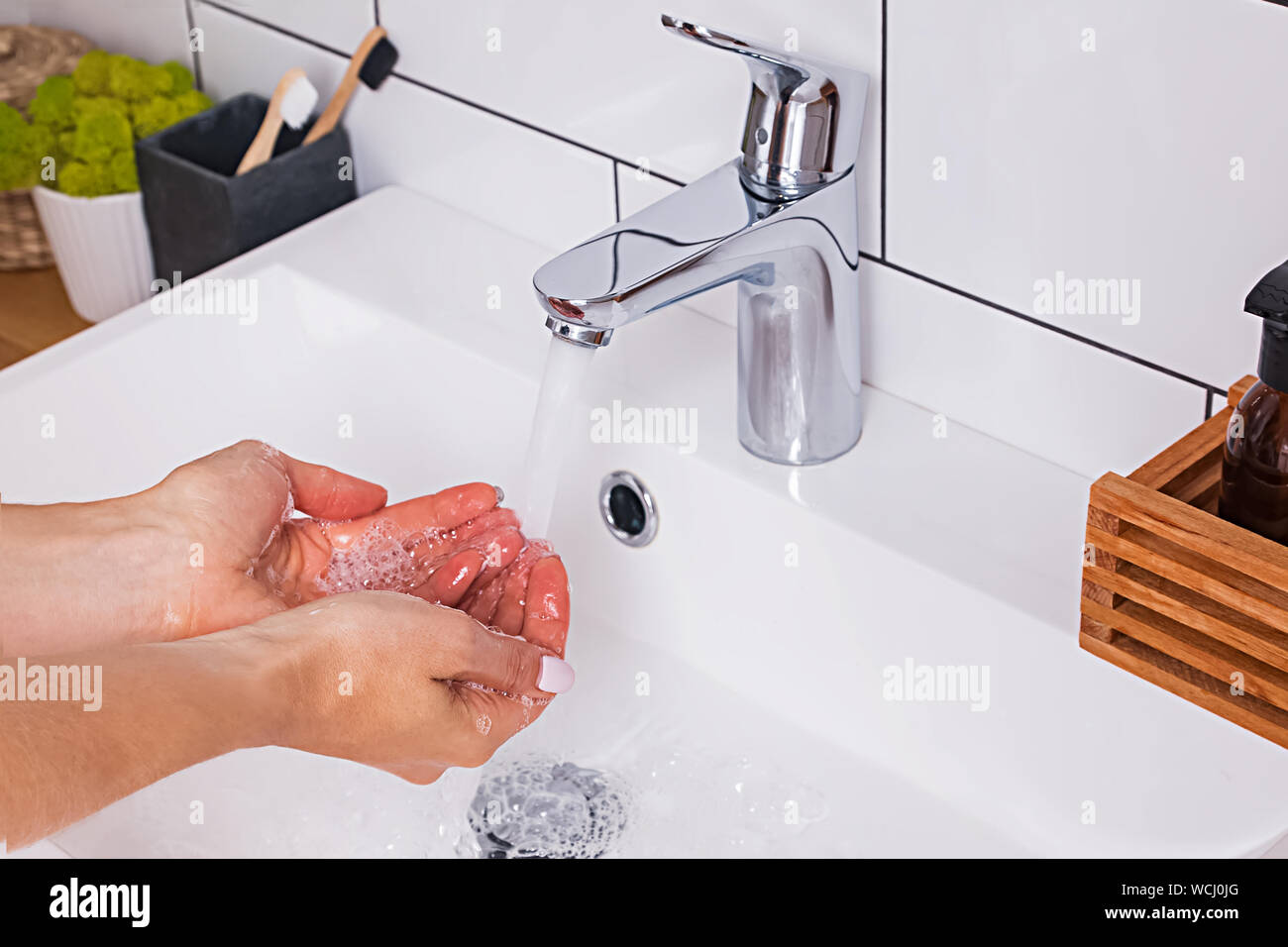 Process of washing hands close-up. Woman's hands rinsing with the water ...