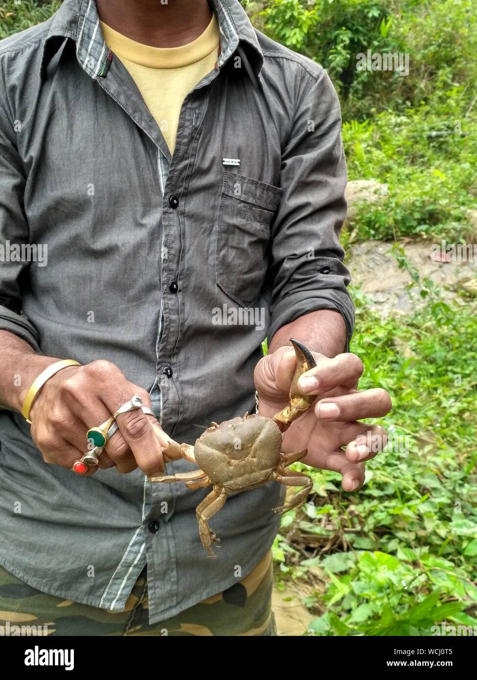 Man holding crab hi-res stock photography and images - Alamy