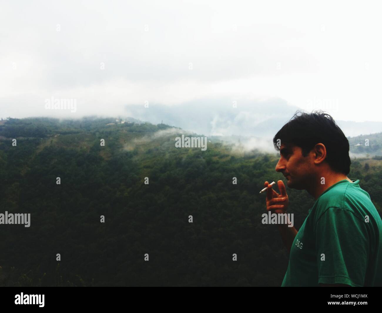 Against tree smoking cigarette hi-res stock photography and images - Alamy